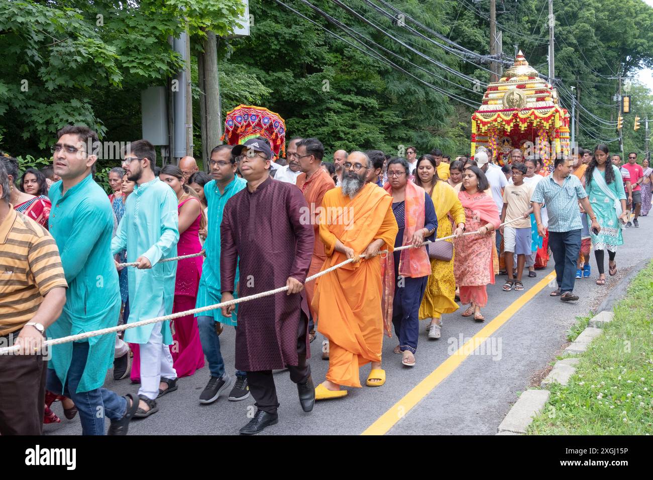 Swami Balgopal, a Hindu Monk, helps pull the heavy chariot with fellow ...