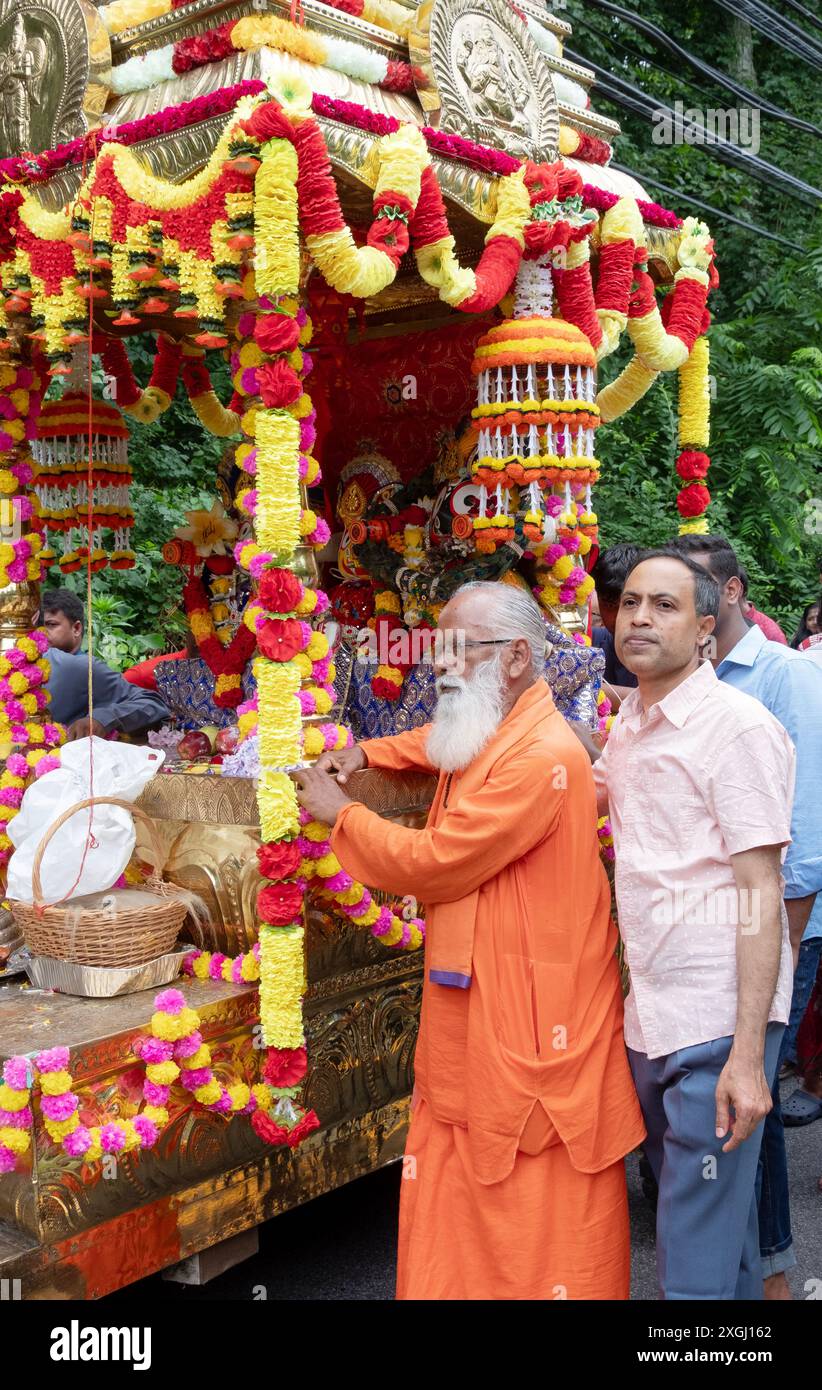Hindu priest Rameshum holds on to the chariot used in the 2024 Ratha ...