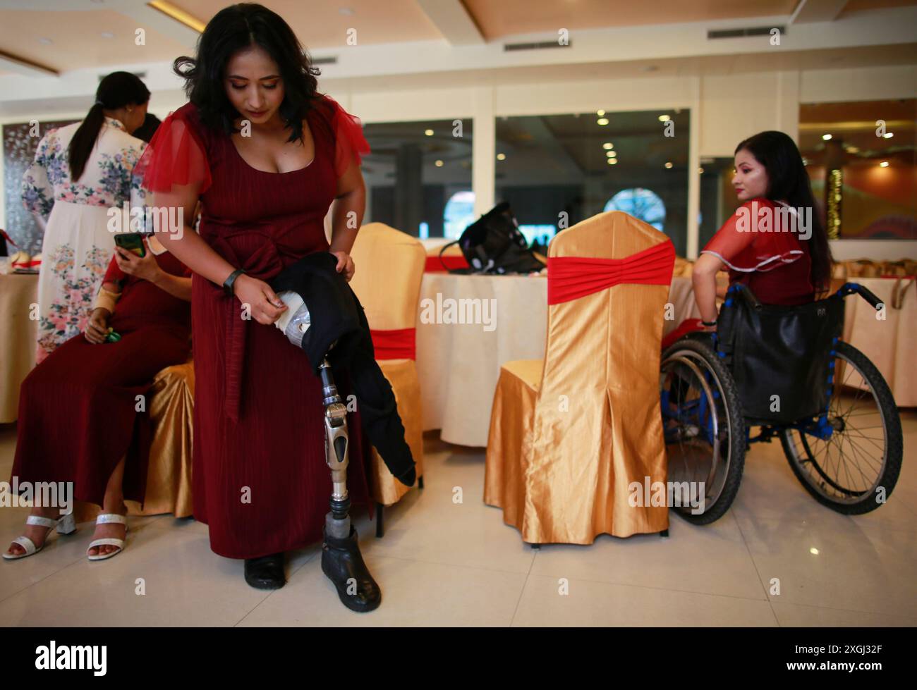 Kathmandu, Nepal. 09th July, 2024. A woman with disabilities puts on ...