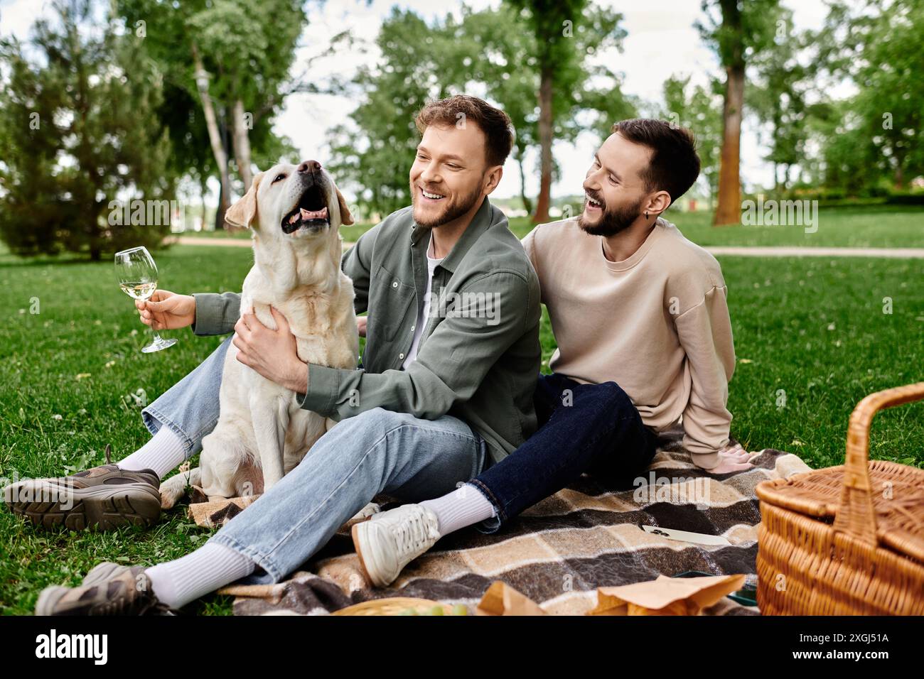 A bearded gay couple enjoys a picnic in a green park with their ...