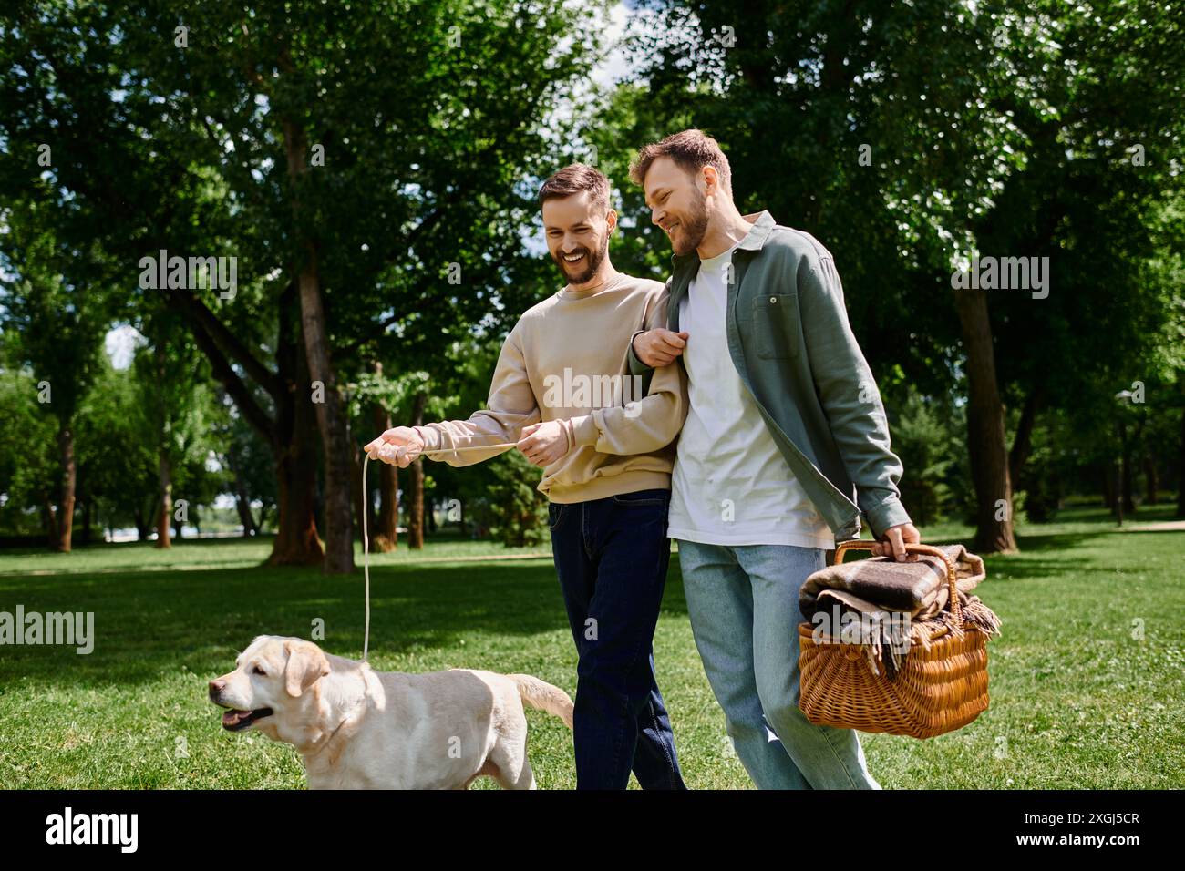 A bearded gay couple walks hand-in-hand with their labrador dog in a ...