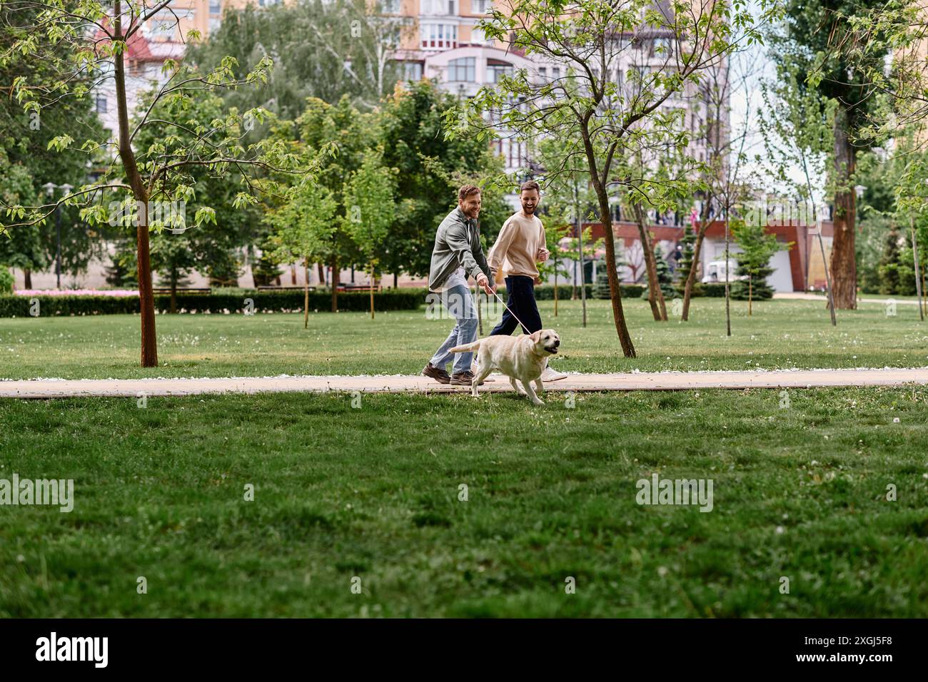 A bearded gay couple walks their labrador dog on a leash through a ...