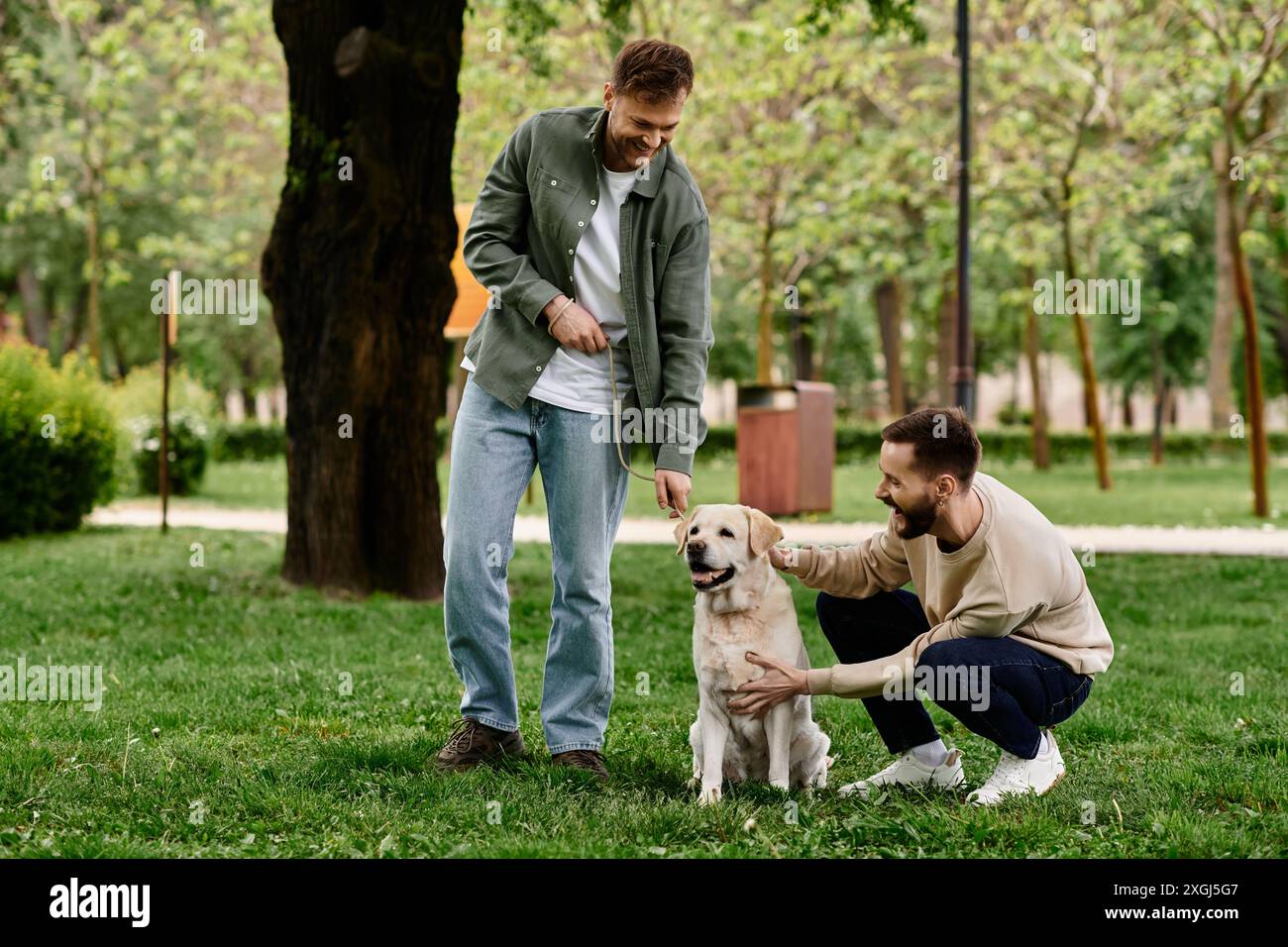 A bearded gay couple is enjoying a walk in a green park with their ...