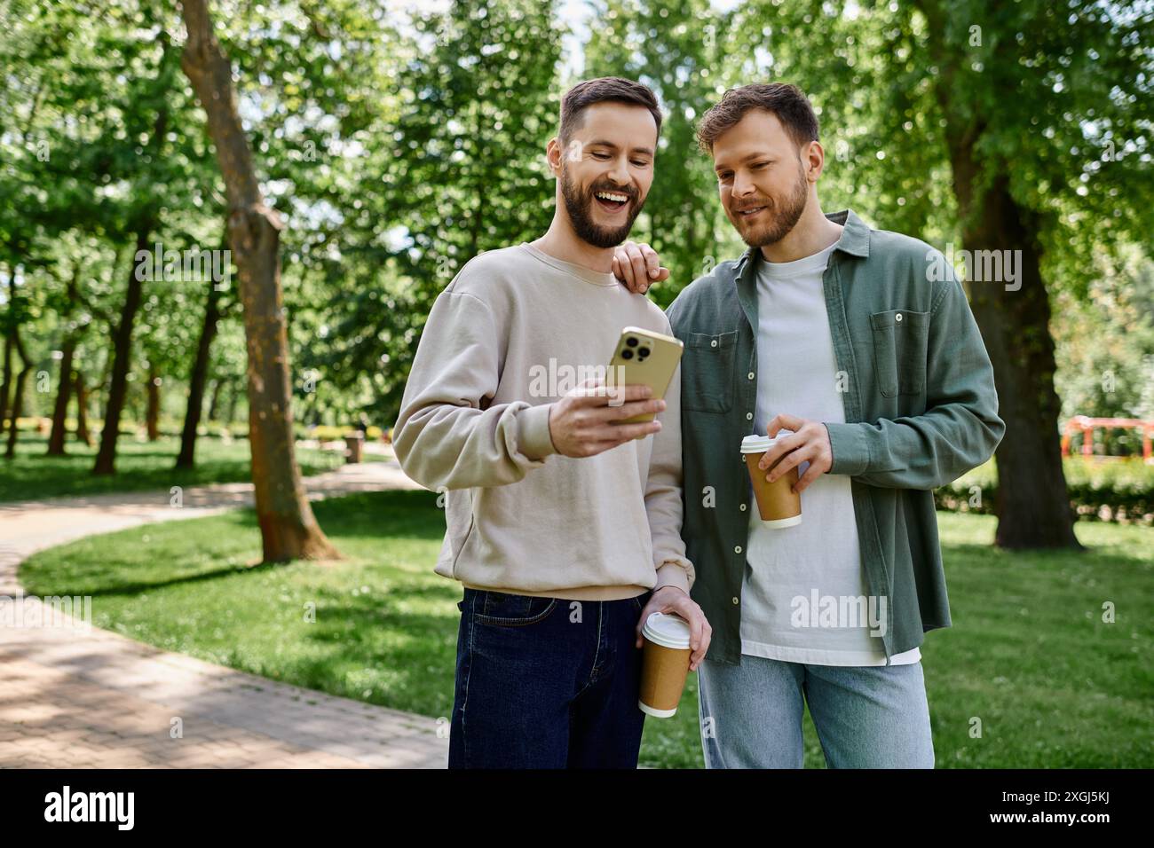 Two Bearded Gay Men Share A Laugh While Enjoying Coffee In A Lush Green