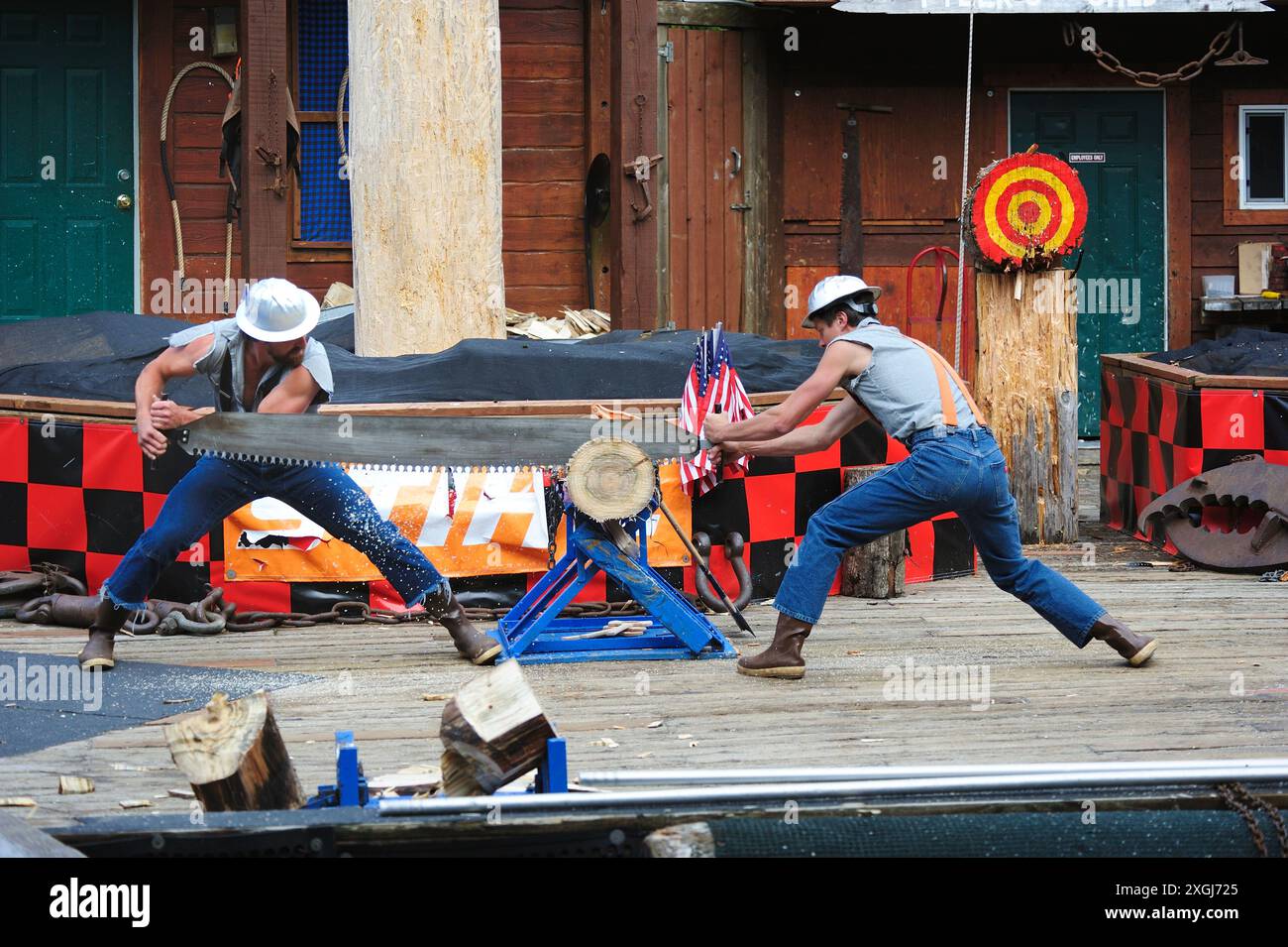 Ketchikan, Alaska, USA - 1st July 2023:Two lumberjacks cutting a log ...