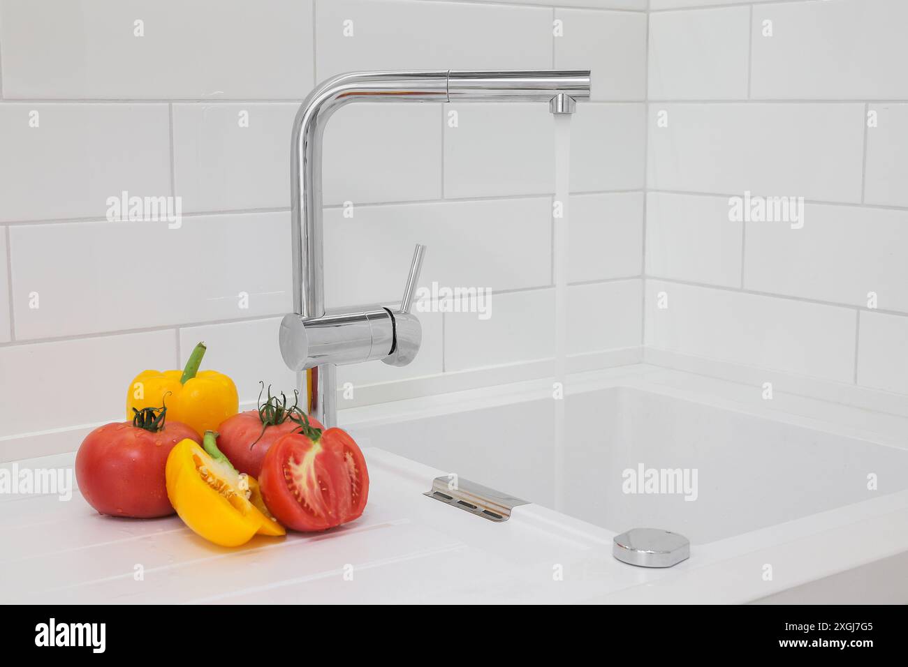 Water pours from the tap close-up in the kitchen interior Stock Photo ...
