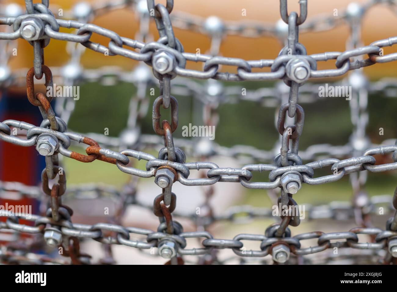 a metal chain connected by a screw and nut Stock Photo - Alamy