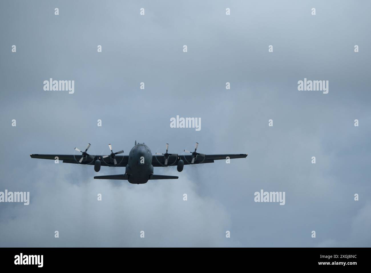 Four-engine turboprop military transport aircraft in the sky. (Lockheed ...