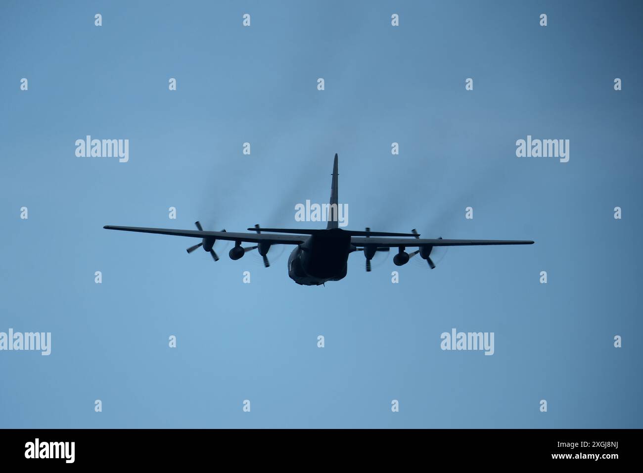Four-engine turboprop military transport aircraft in the sky. (Lockheed ...