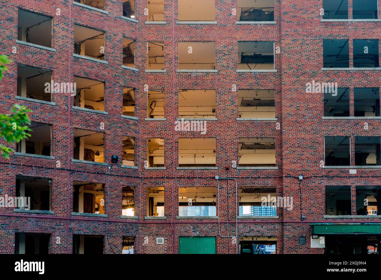 Apartment building under demolition with windows removed, leaving ...