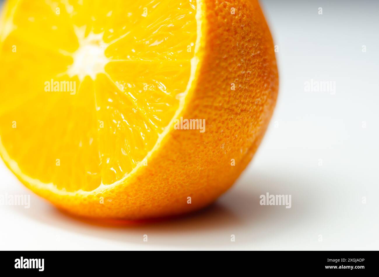 A half of orange with the white part of the fruit visible, healthy food ...