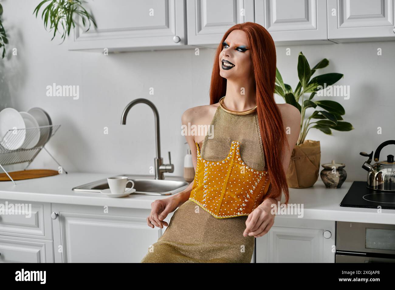 A glamorous drag queen poses in a kitchen, showcasing her stylish ...