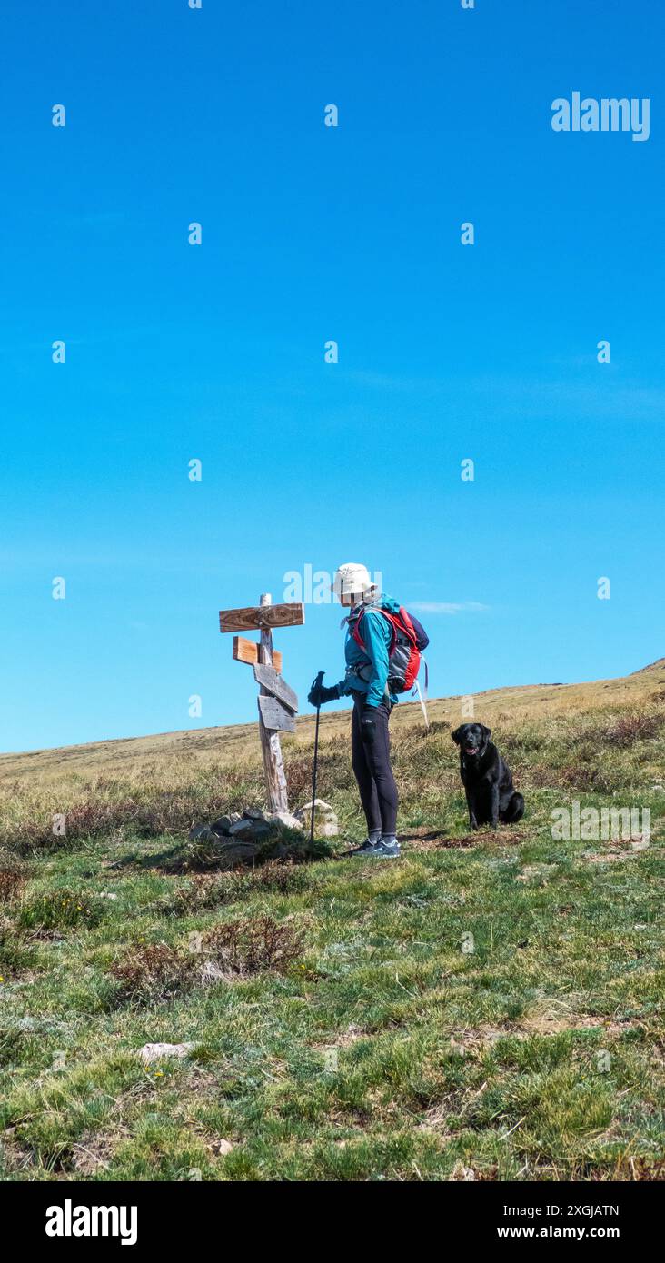 Single woman and her faithful Black Lab hiking Gold Hill in the Sangre ...