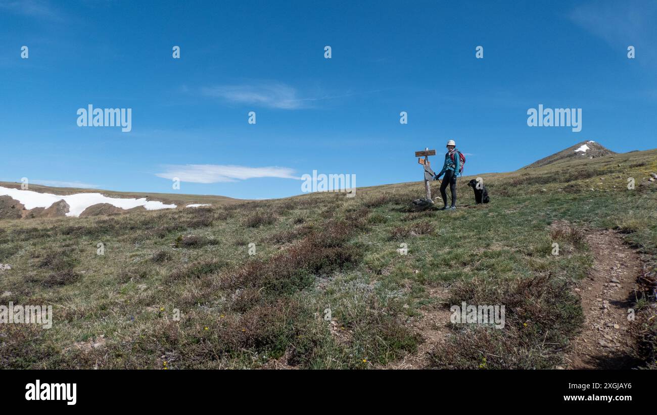 Single woman and her faithful Black Lab hiking Gold Hill in the Sangre ...
