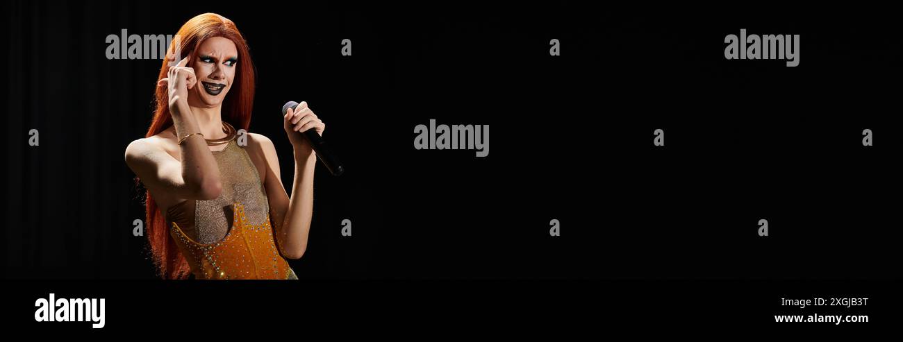 A drag performer in a glamorous outfit holds a microphone and poses for ...