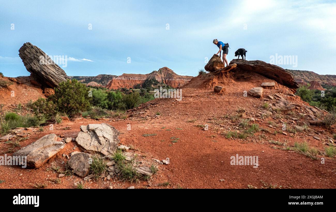 A single woman and her black lab hiking in Palo Duro Canyon State Park ...