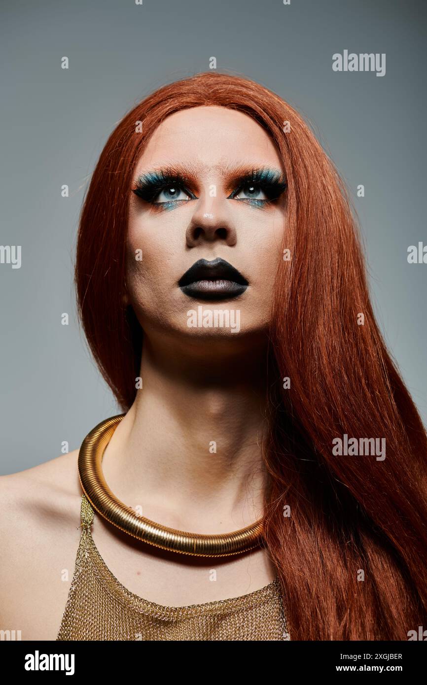 A drag performer in a golden outfit looks up with a dramatic expression ...