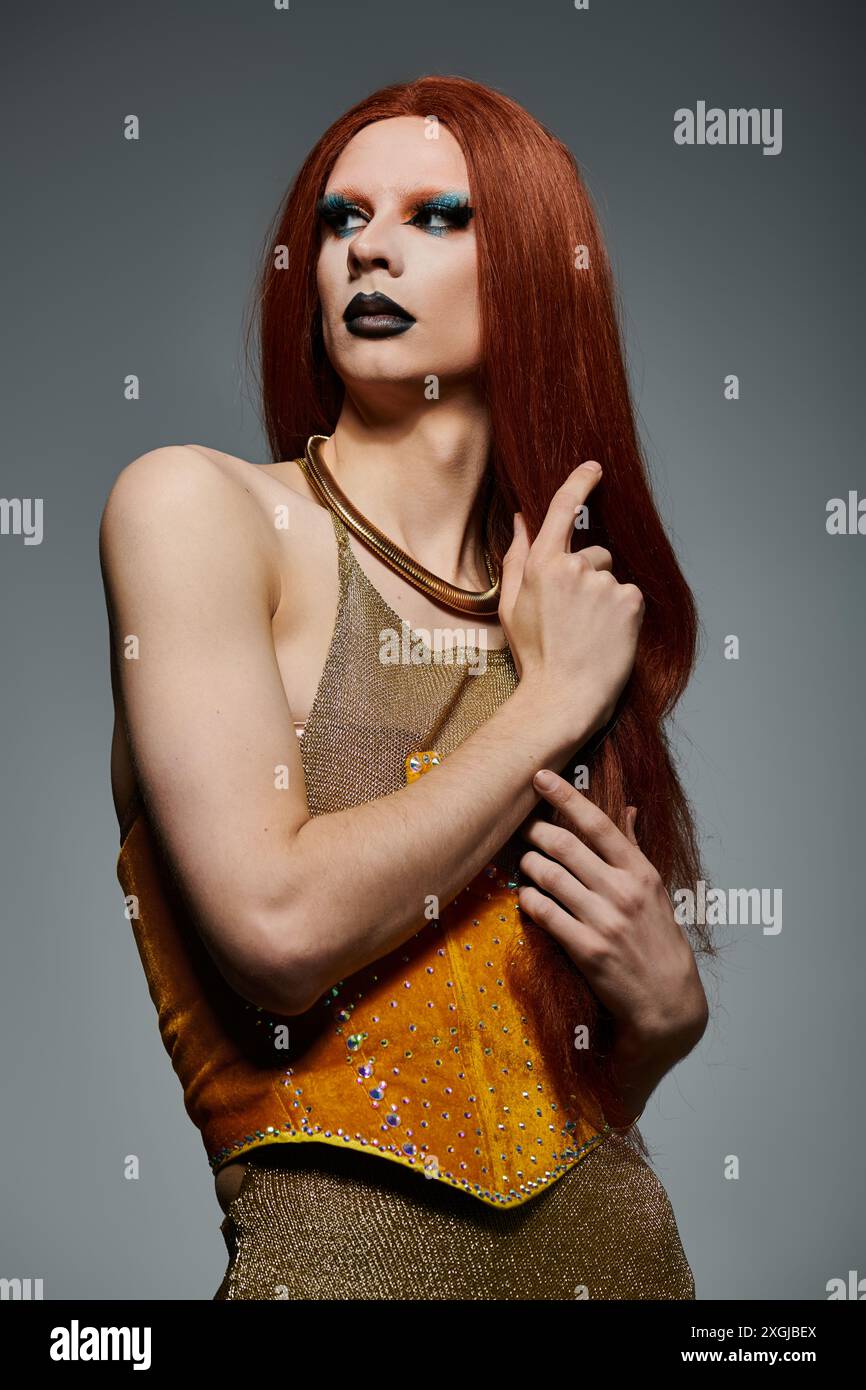 A drag queen in a golden corset and mesh top poses for a photoshoot ...
