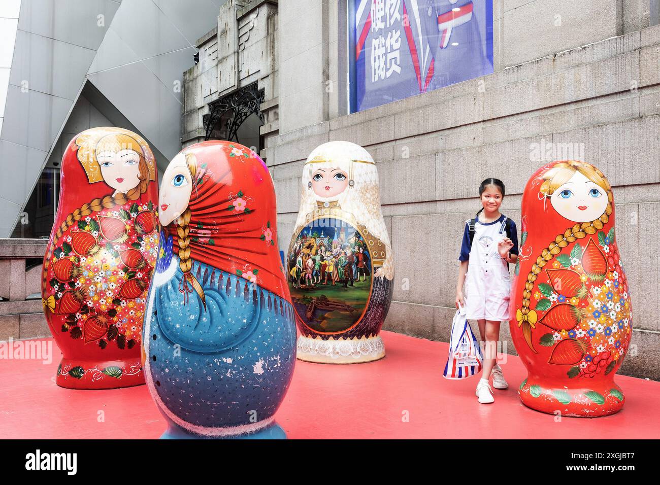 Wuhan, China. 09th July, 2024. A girl poses for photos with matryoshka ...