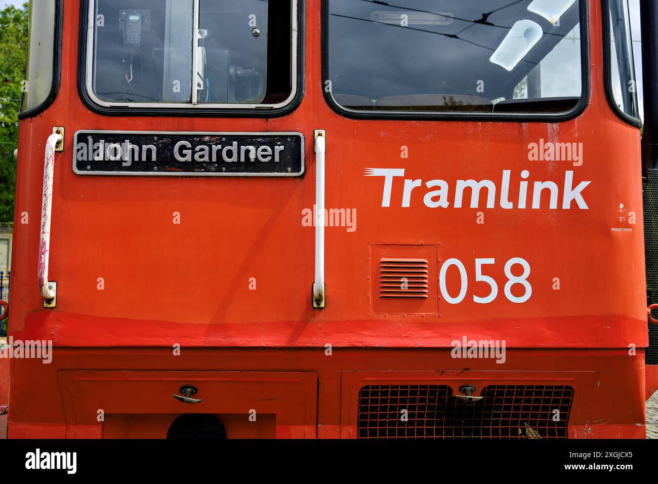 Close-up of an orange tram with the makers name 'John Gardner' and the ...