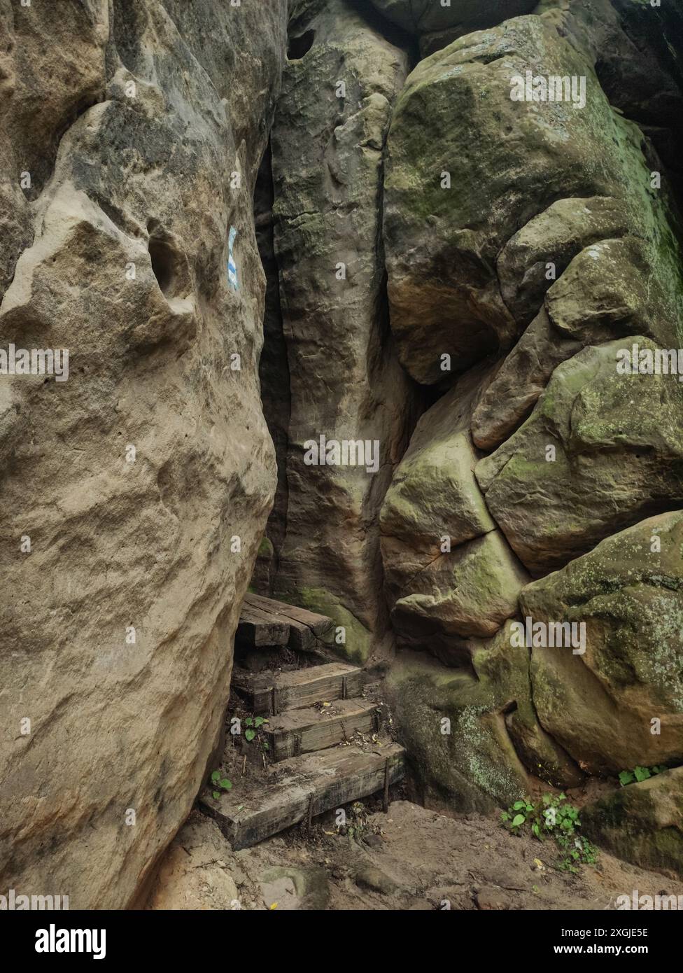 A narrow, rocky path leads up through a gap in a cliff. Vertical mobile ...