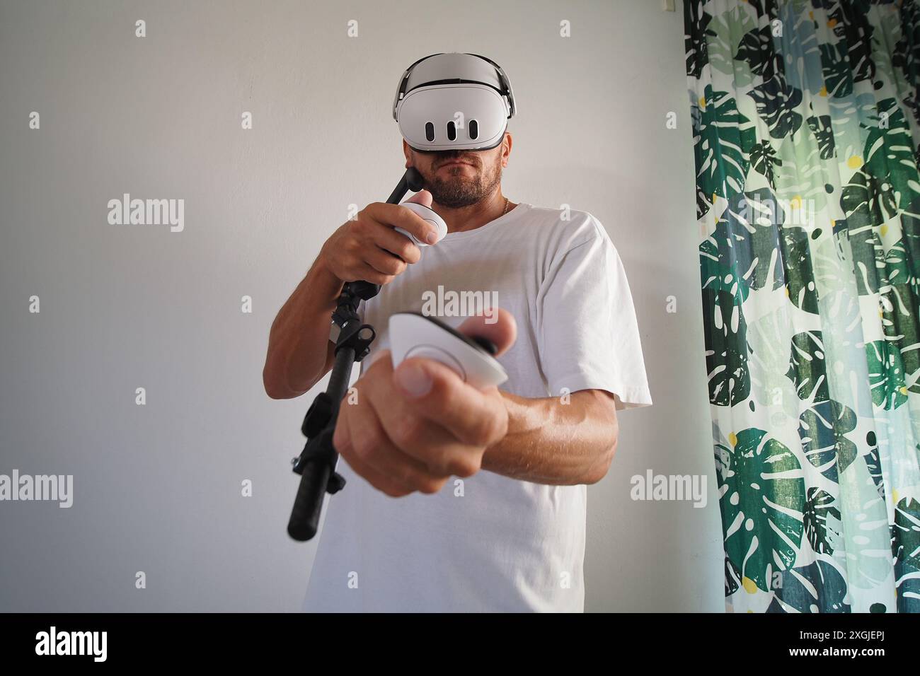 Man playing VR shooters game with gunstock Stock Photo - Alamy