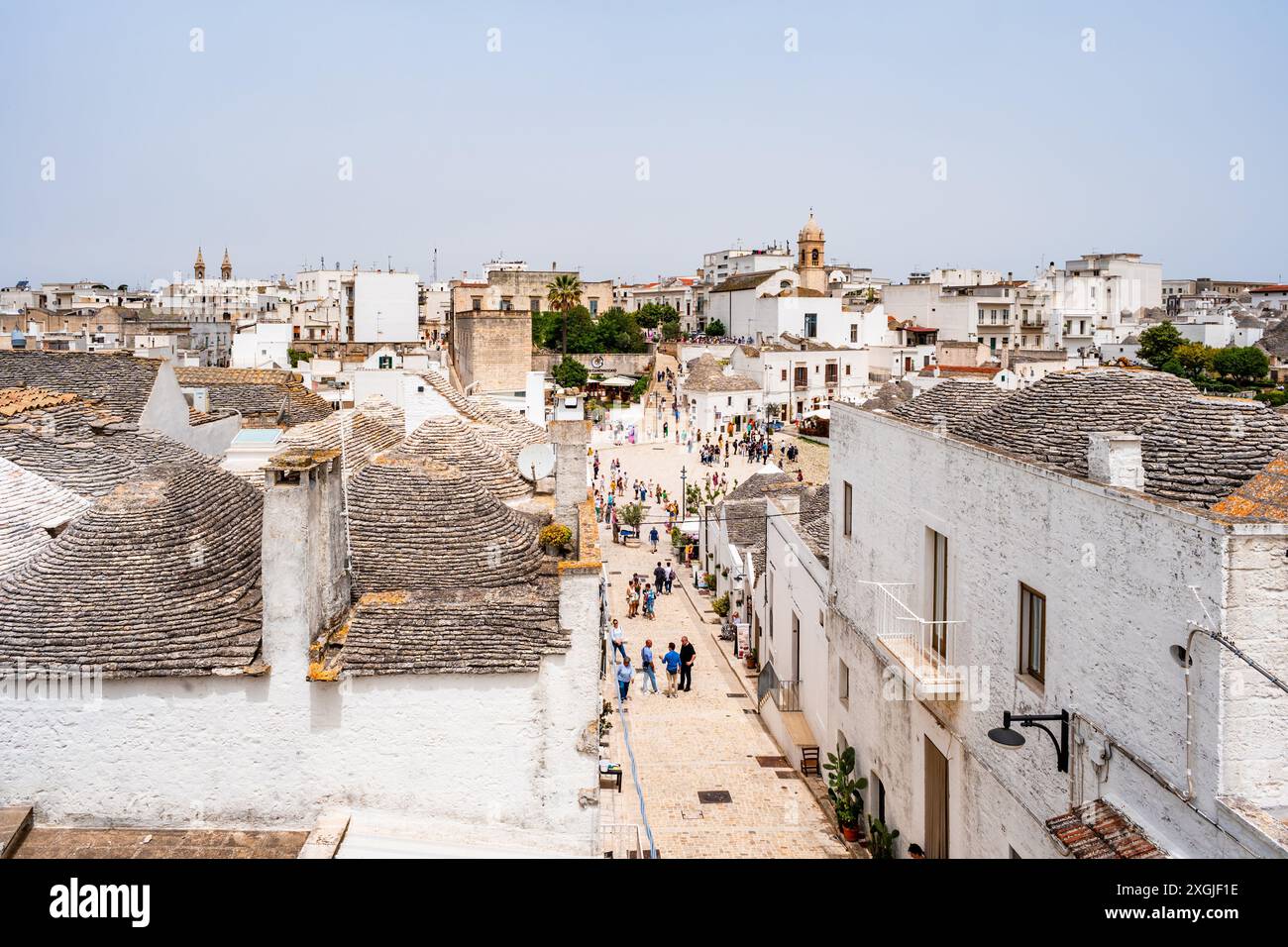 ALBEROBELLO, ITALY - MAY 18, 2024: Tourists sightseeing in Alberobello ...