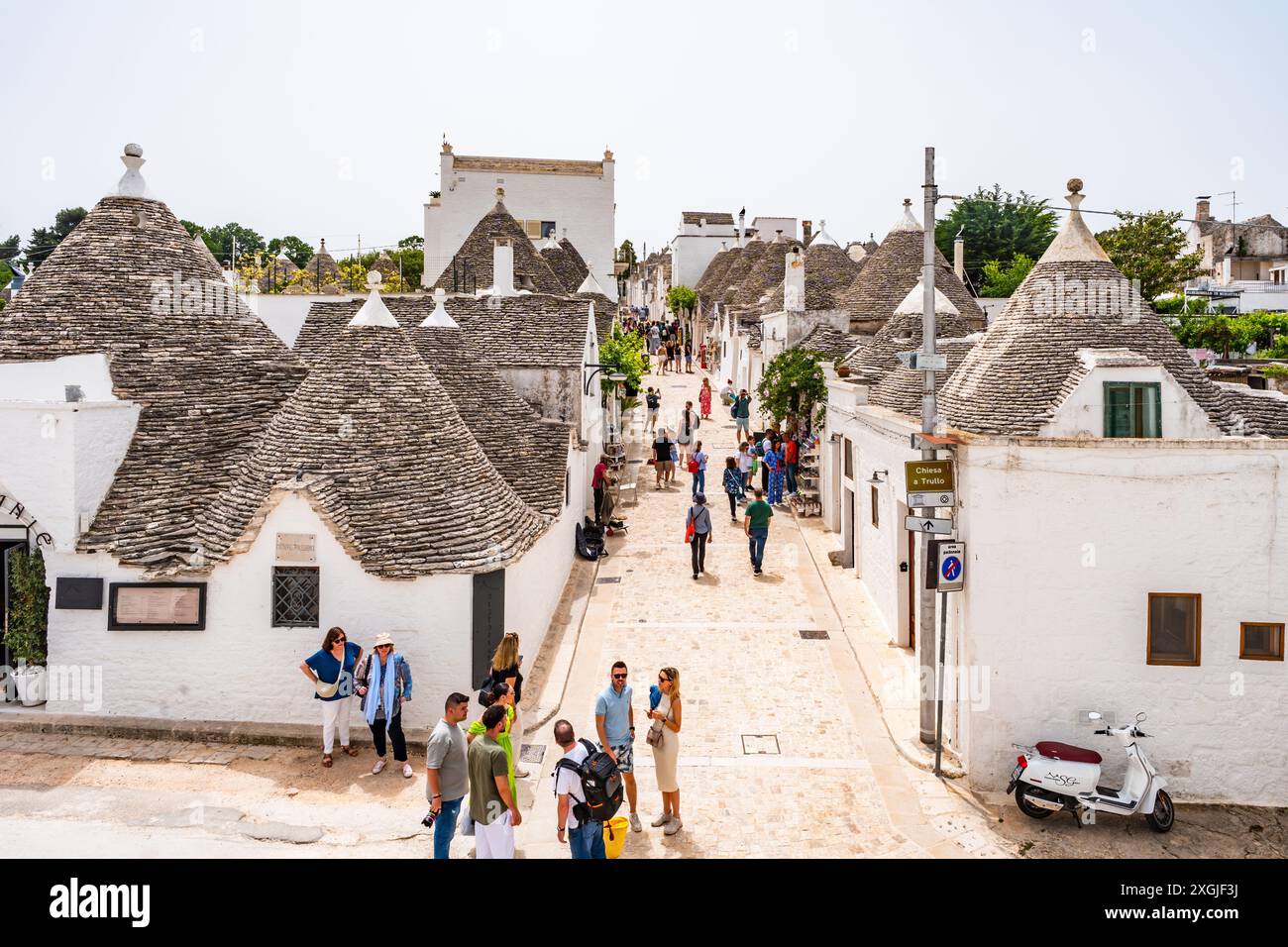 ALBEROBELLO, ITALY - MAY 18, 2024: Tourists sightseeing in Alberobello ...