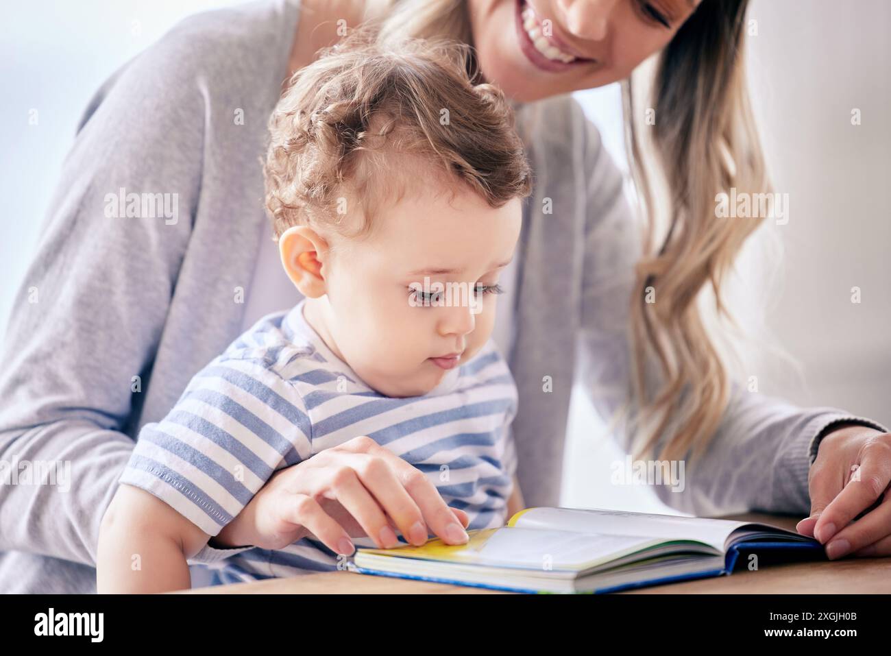 Mother, baby and reading book for story in home, literacy and learning ...