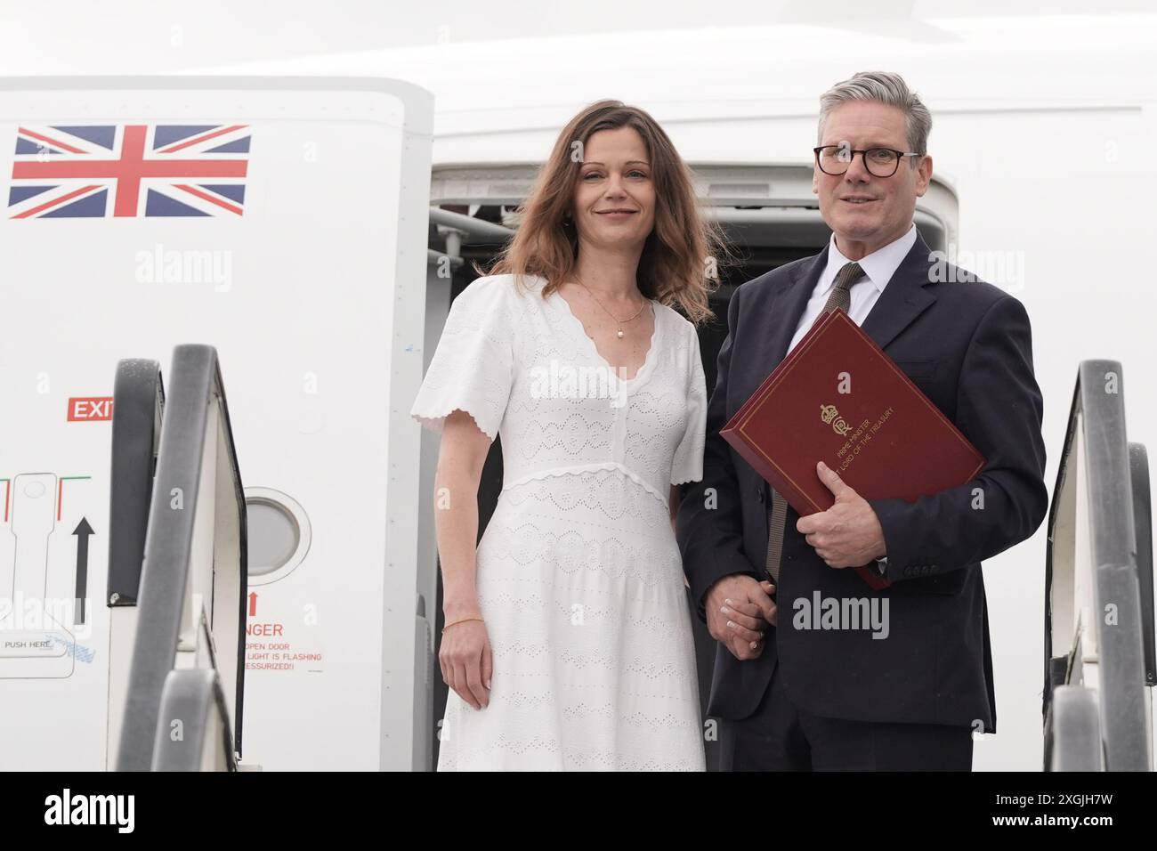 Prime Minister Sir Keir Starmer and his wife Victoria board a plane at ...
