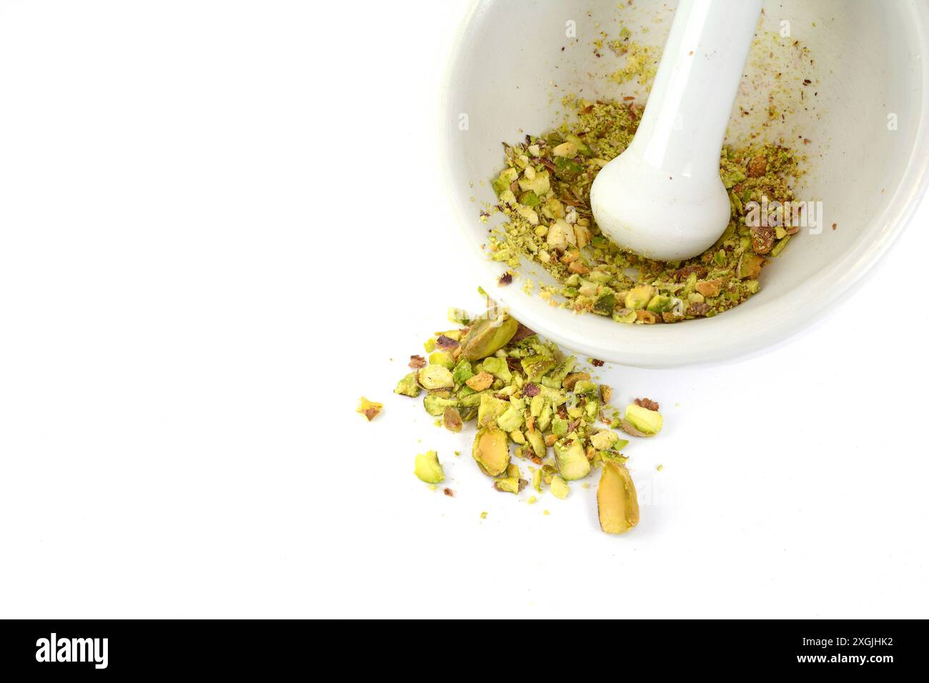 Ground, milled, crushed or granulated pistachio pile with pestle and ...