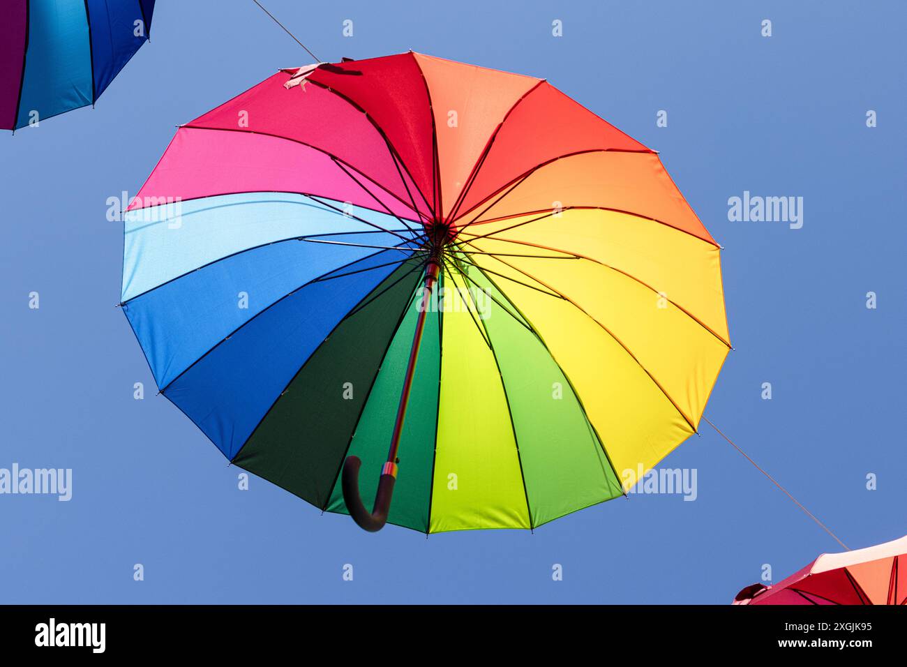 Colorful umbrellas hanging in the air as urban decoration representing ...