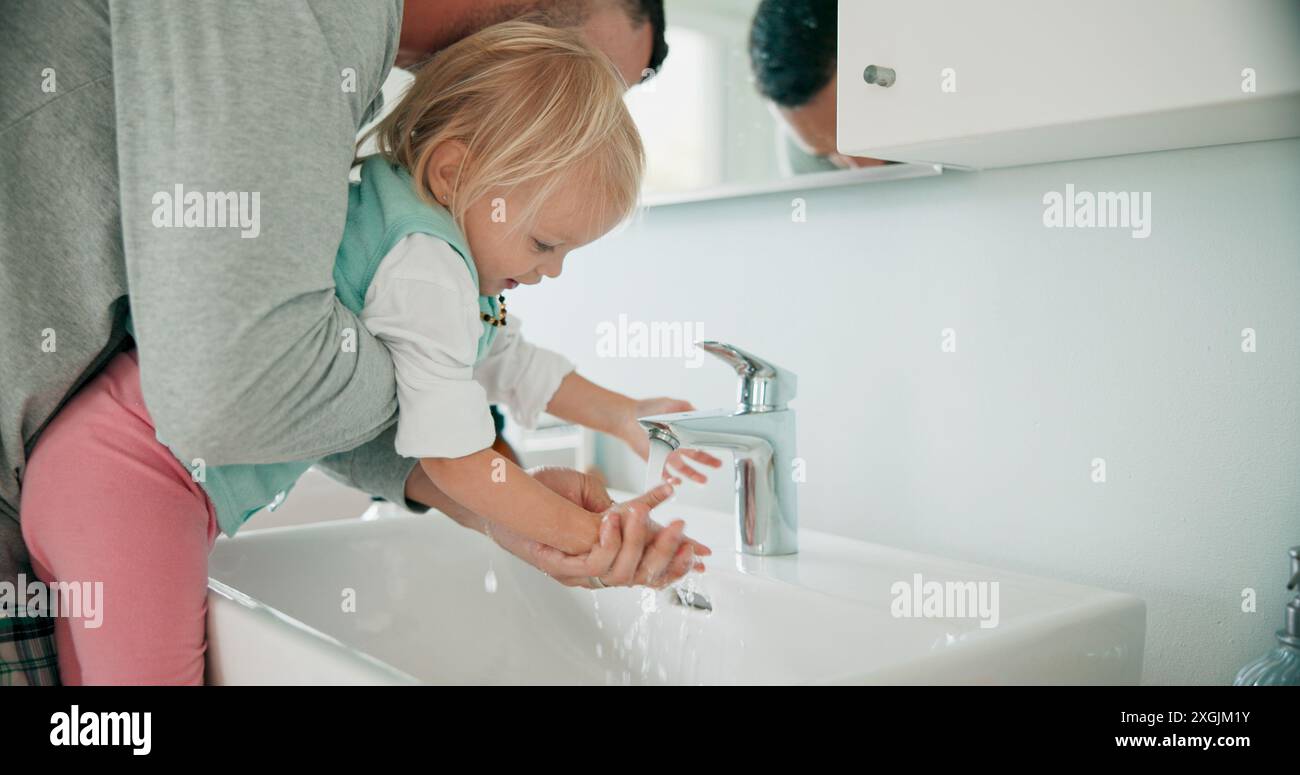 Child, dad and washing hands in bathroom for growth, development and ...