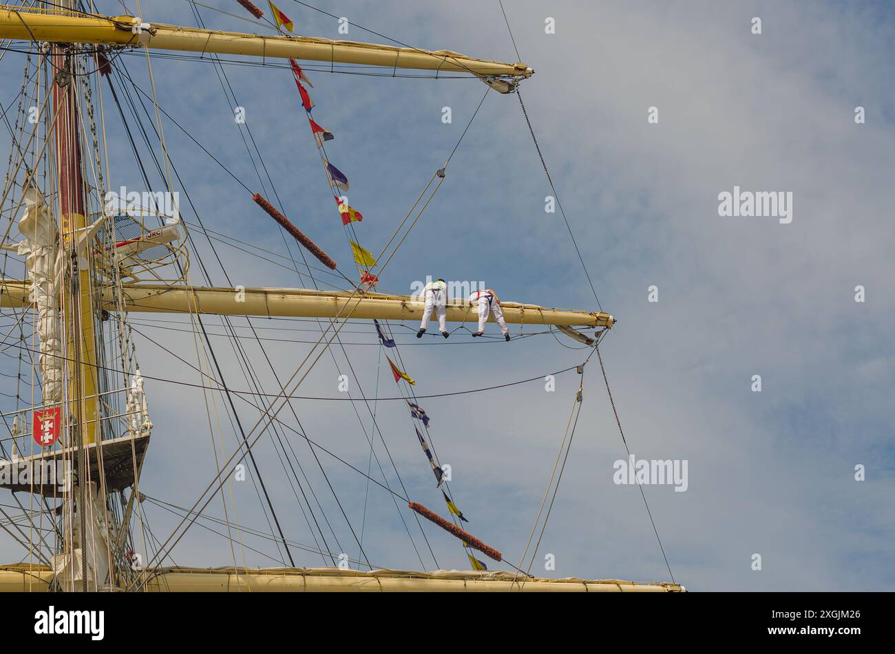 Masts and rigging of a sailing ship against blue sky and clouds. High ...