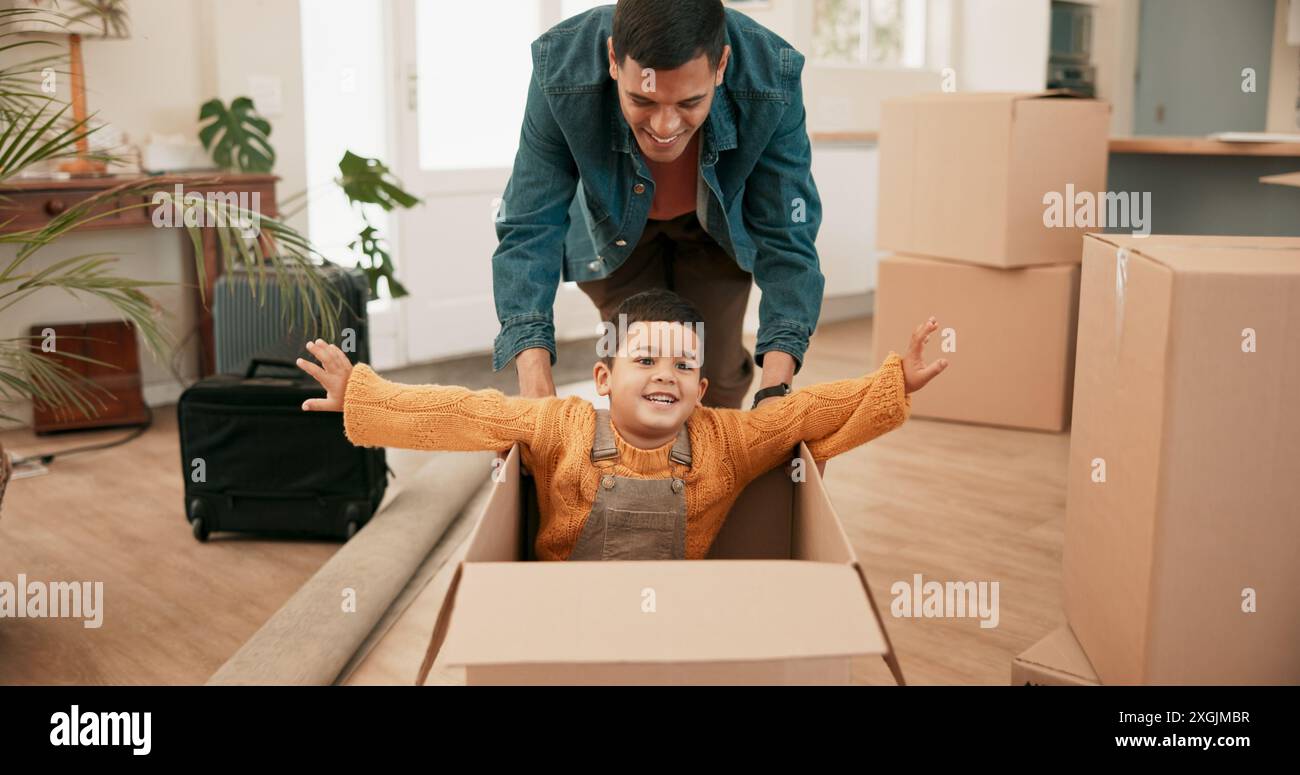 Father, boy and push box in new home with smile for plane, spaceship or ...