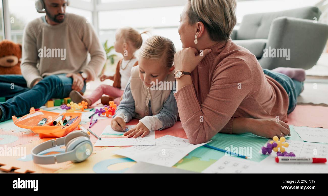 Parents, children and drawing for education on floor with family ...