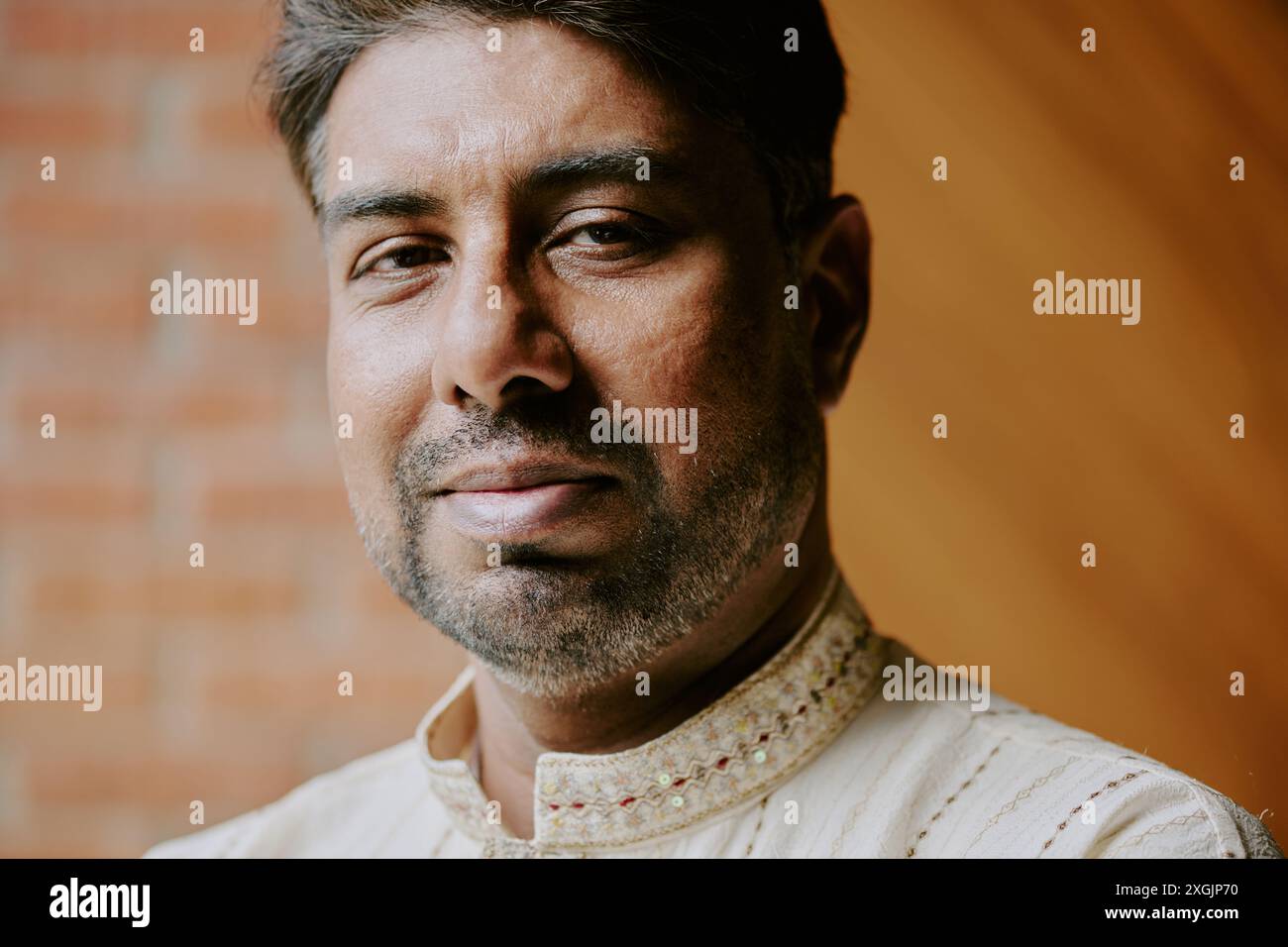 Portrait of Indian confident man looking directly at camera and ...