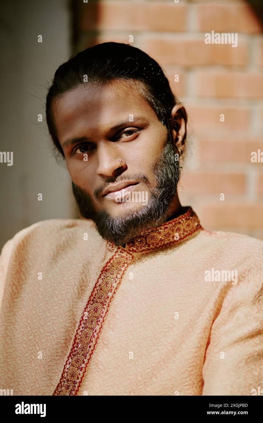 Handsome Indian man with dark chocolate eyes and dressed in patterned ...