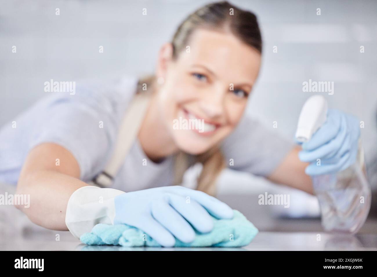 Spray, portrait and woman wipe kitchen counter with cloth for hygiene ...