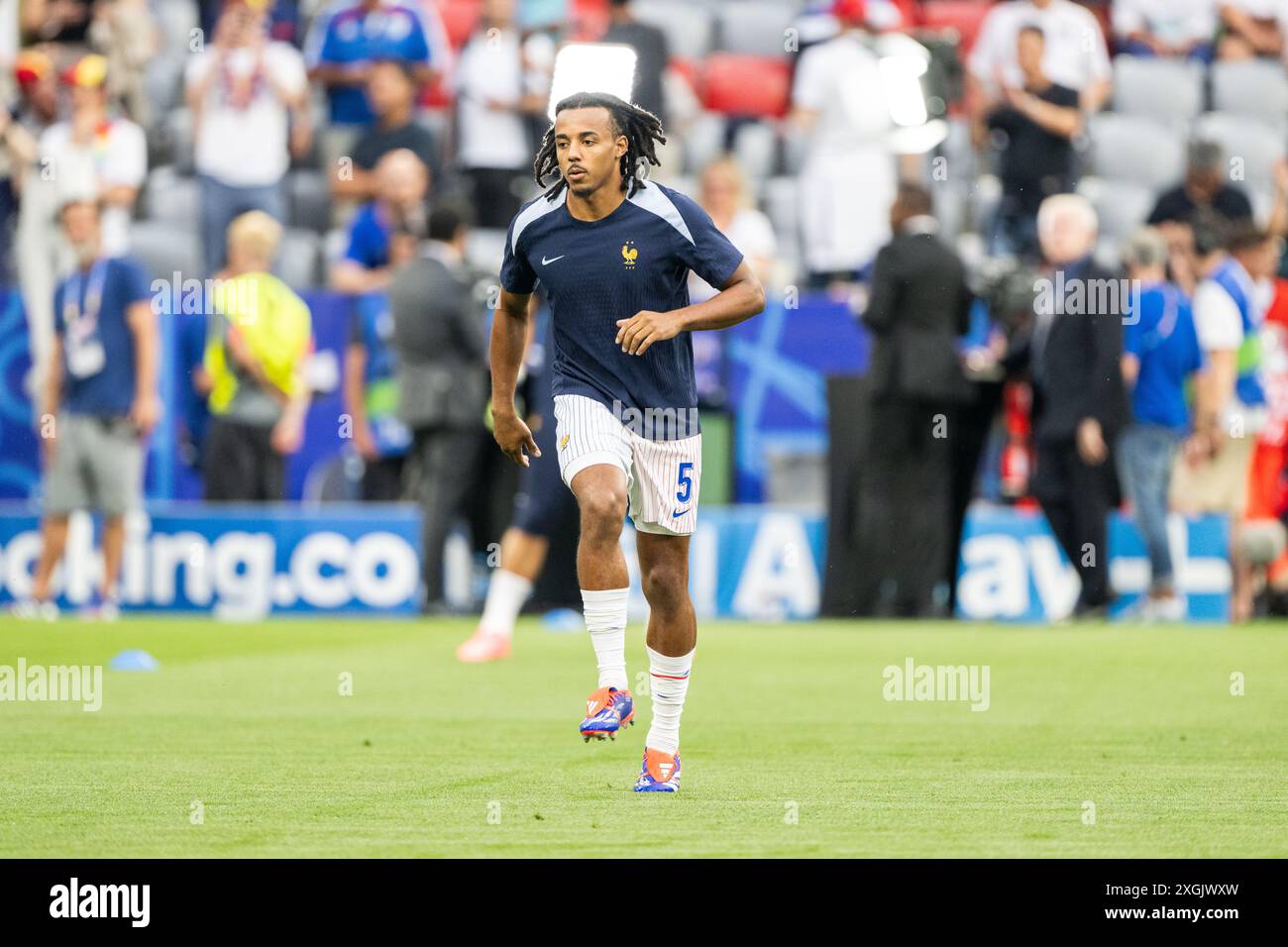 Munich, Germany. 09th July, 2024. Jules Kounde (5) of France is warming ...
