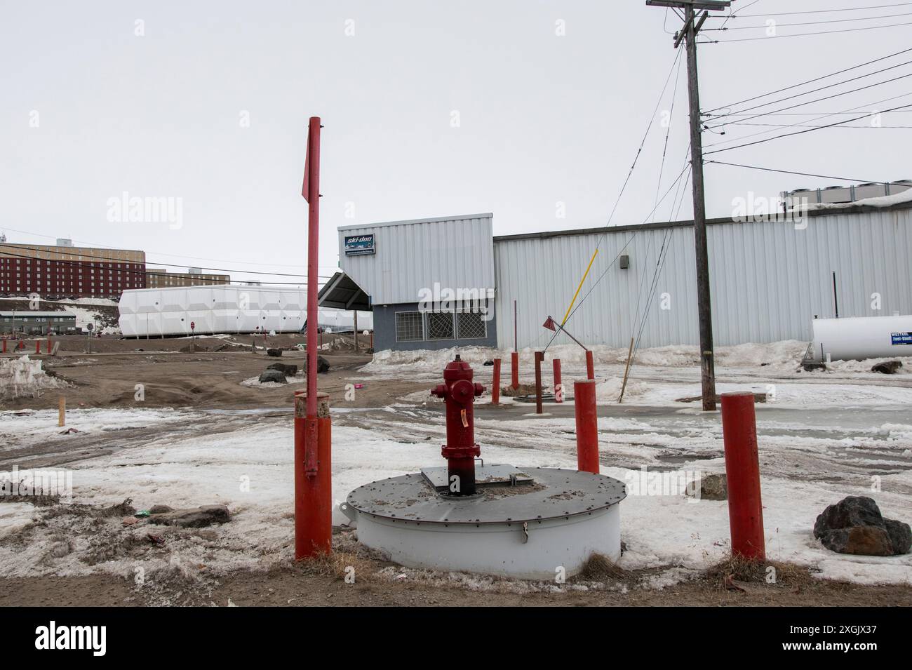 Red fire hydrant protected by bollards on Iglulik Drive in Iqaluit ...