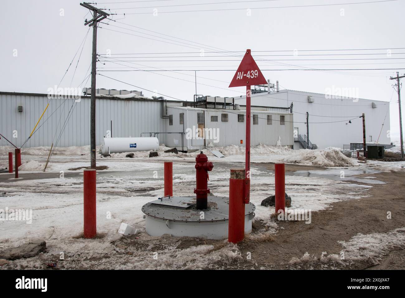 Red fire hydrant protected by bollards on Iglulik Drive in Iqaluit ...