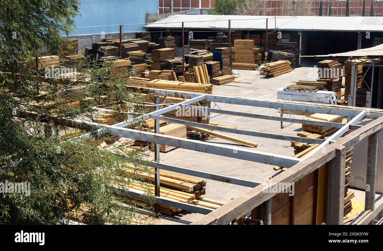 Aerial view of a large lumber yard featuring organized stacks of wooden ...