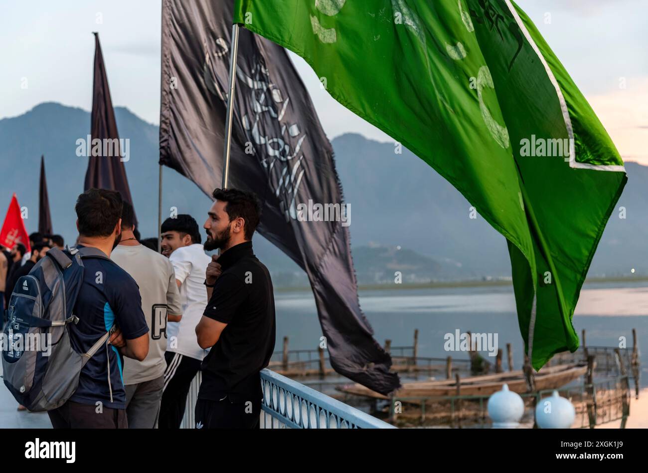 Kashmiri Shia Muslims are seen holding religious flags on a road during Muharram. Muharram ...