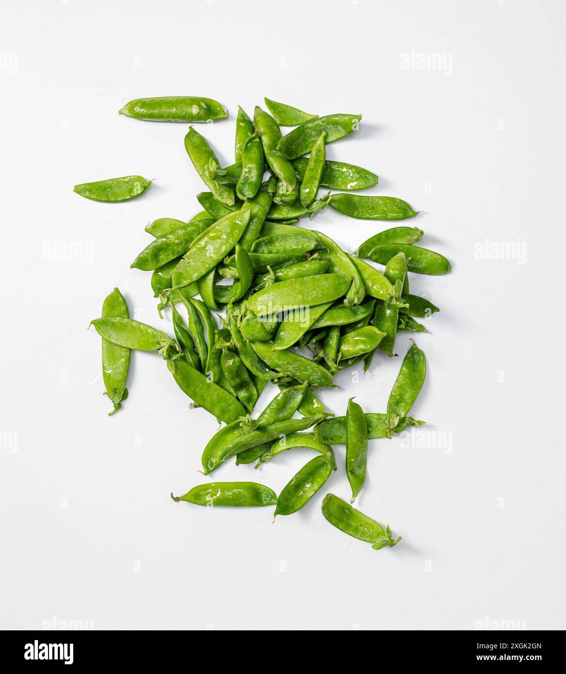 "Top view of fresh sugar snap peas scattered on a clean white ...