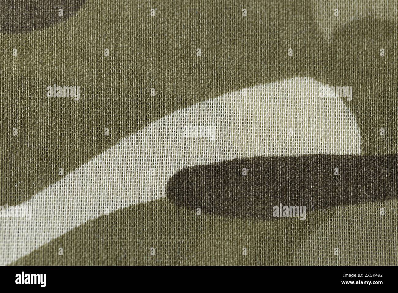 A close up of a piece of camouflage fabric. The fabric is a mix of ...