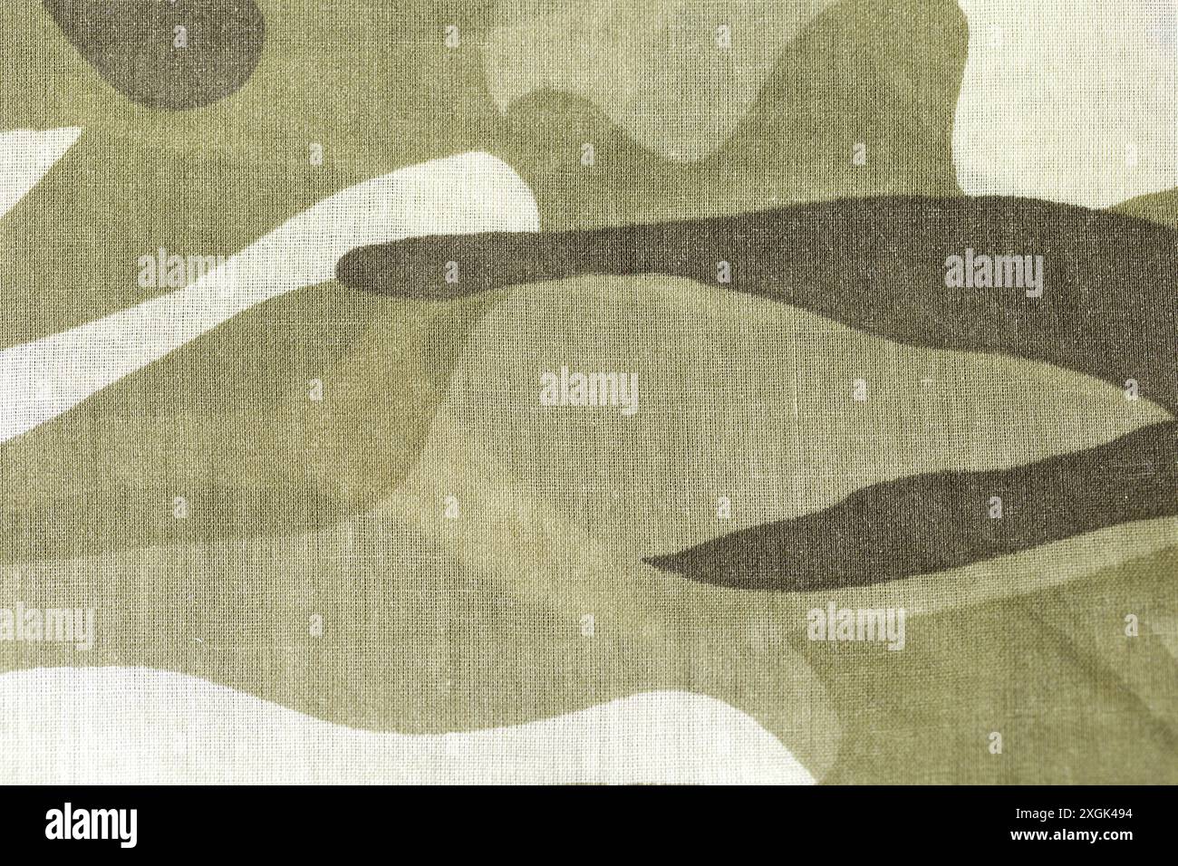 A close up of a piece of camouflage fabric. The fabric is a mix of ...