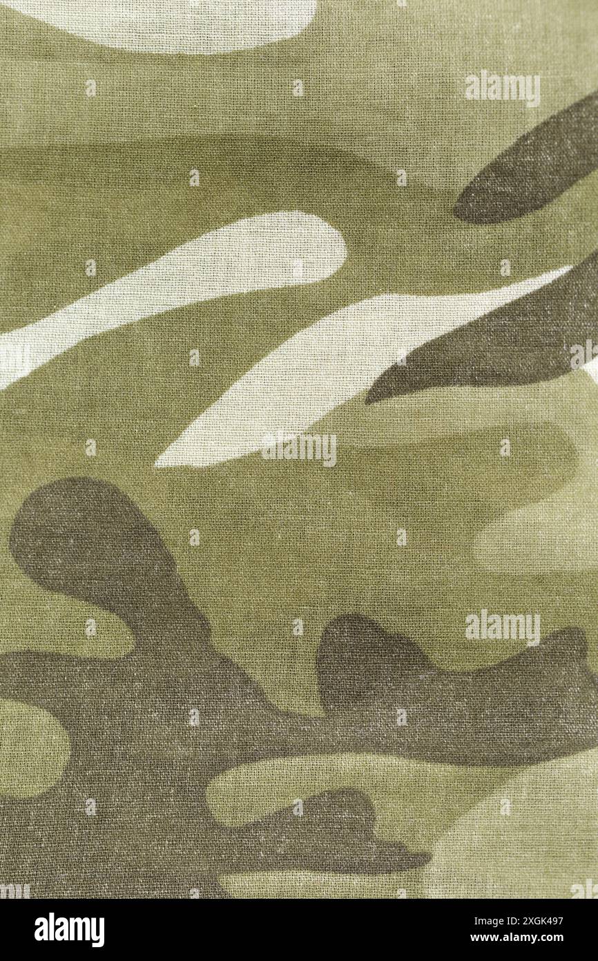 A close up of a piece of camouflage fabric. The fabric is a mix of ...