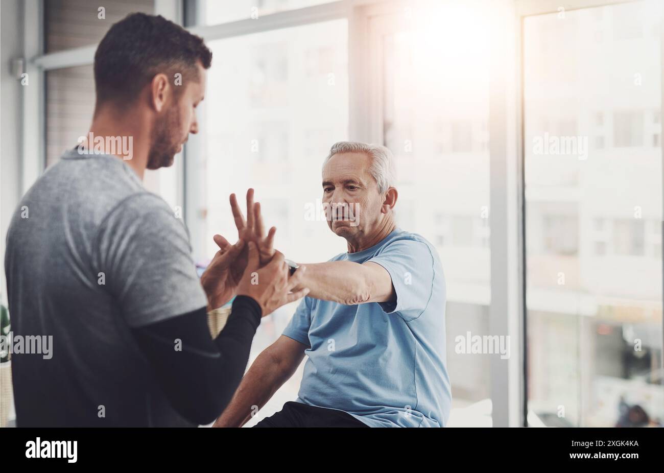 Physiotherapy, elderly man and hand with stretching for recovery ...