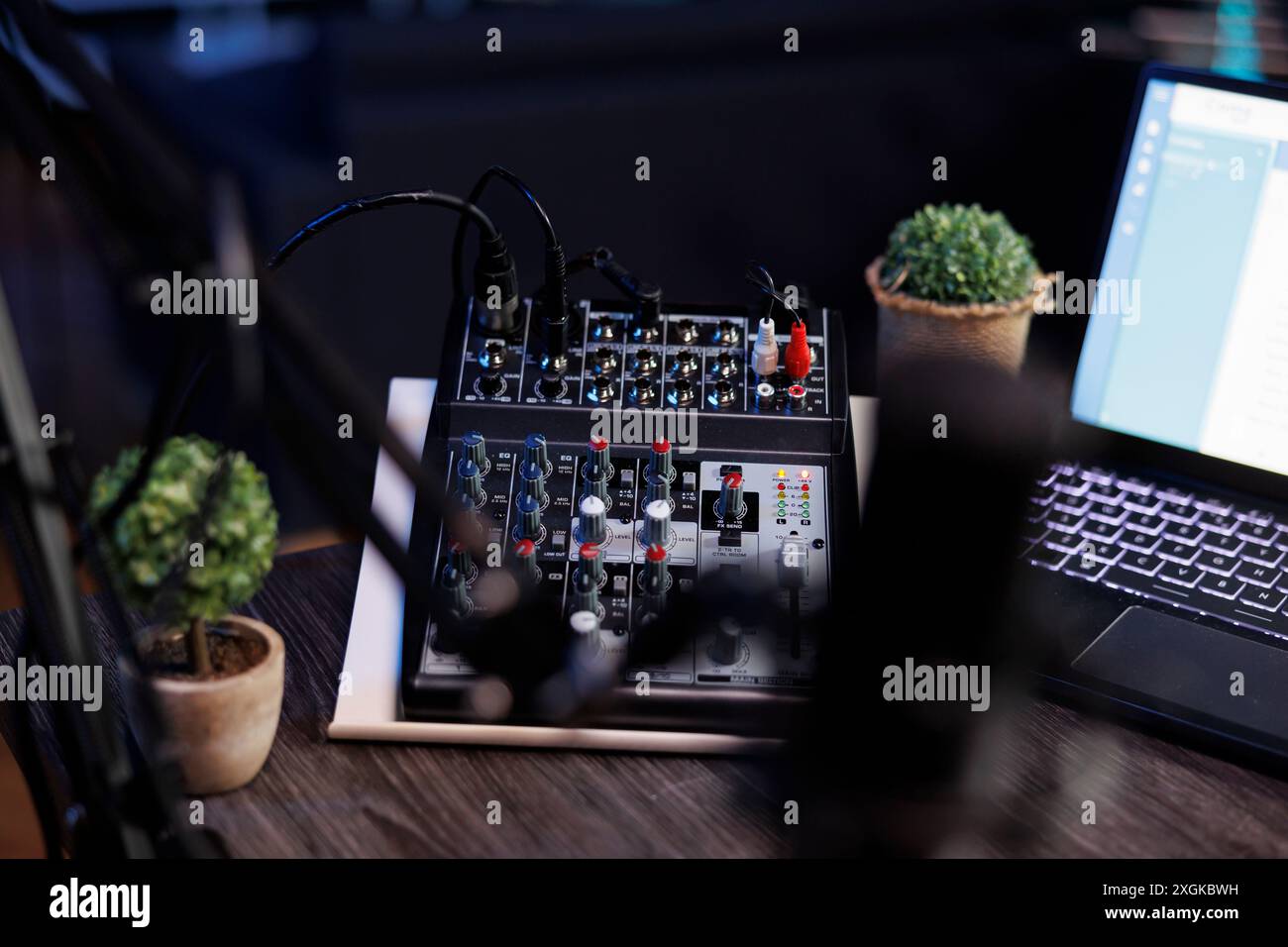 Professional podcasting setup with laptop, modern audio mixer and ...